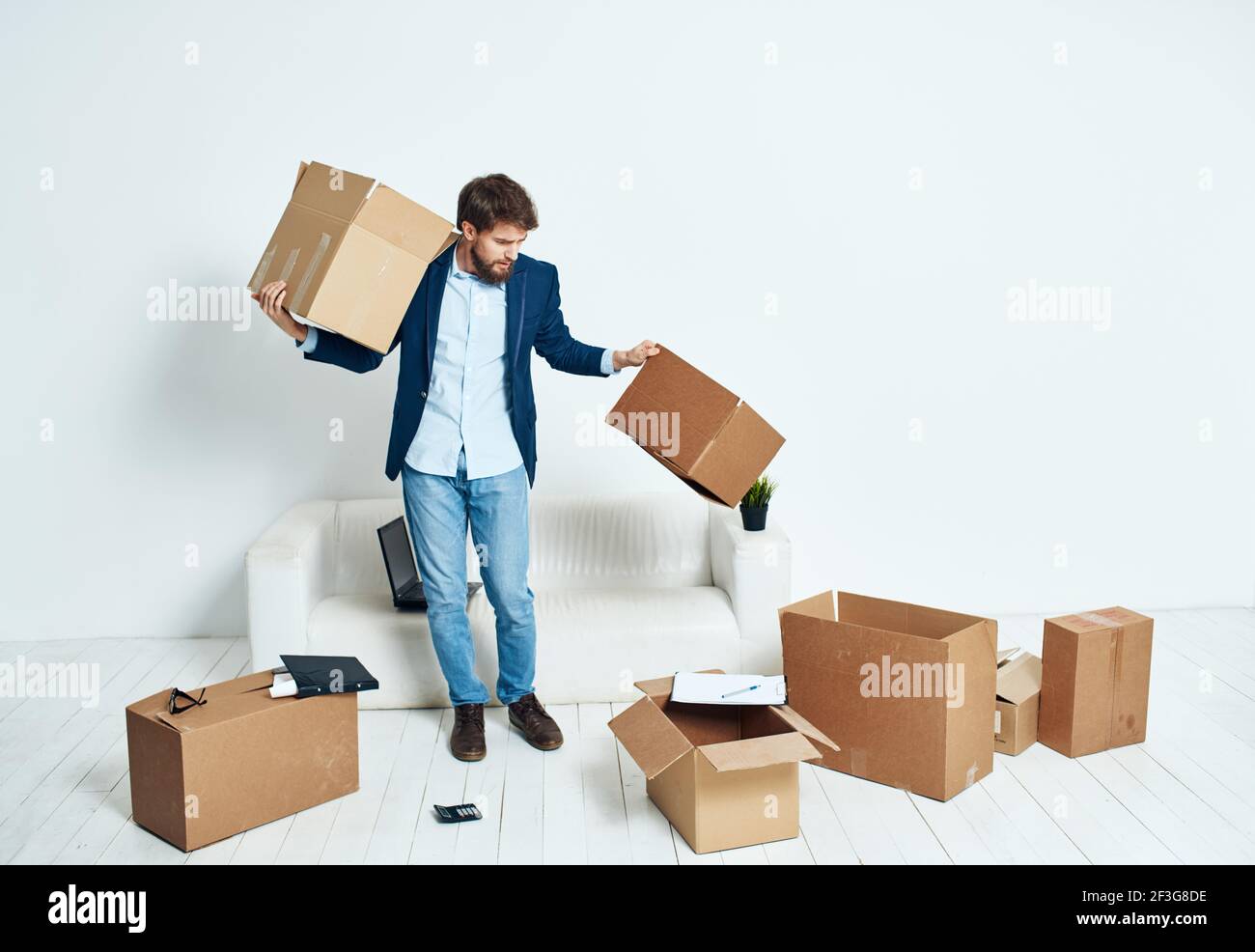 Business man in a suit boxes in hands picking things moving Stock Photo ...