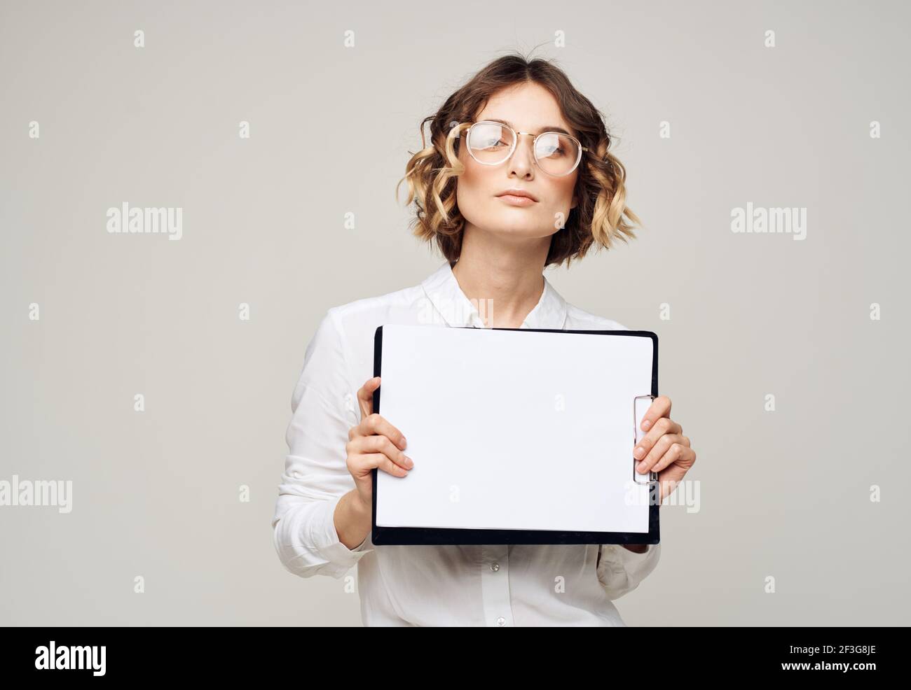 Woman on light background with document folder white shirt glasses ...