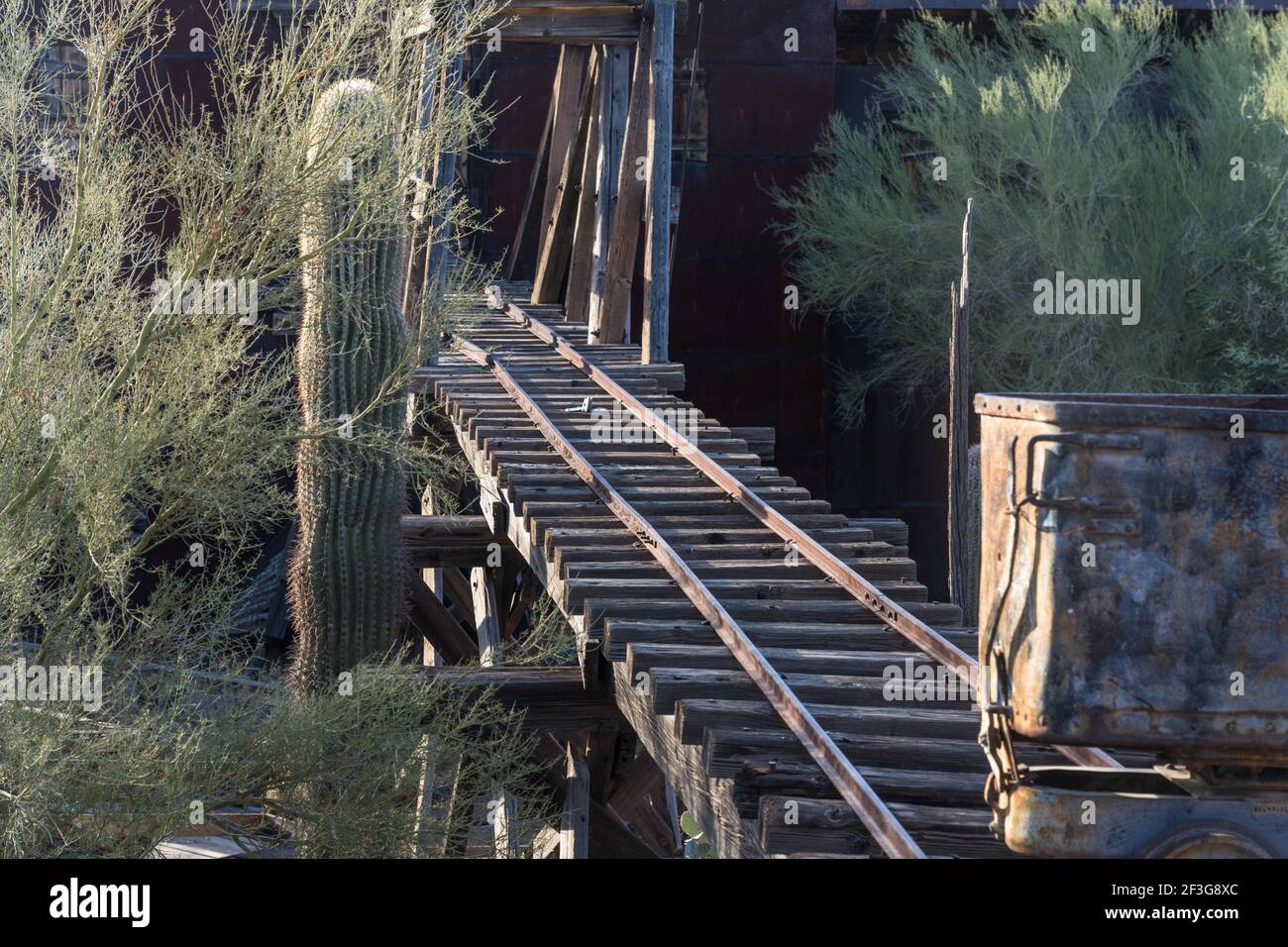 An old mine track and ore car in the old mining ghost town of Goldfield ...