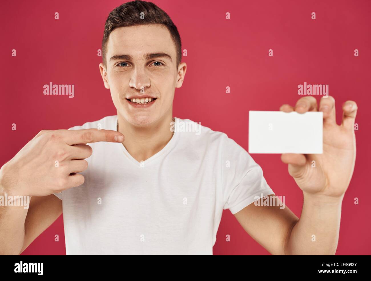 A guy with a business card in his hand gestures and emotions red ...