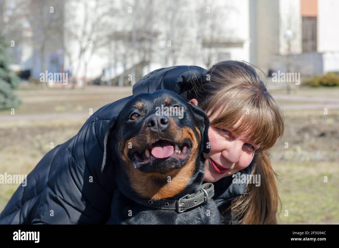 Portrait of a happy woman hugging her pet. An adult woman and a ...