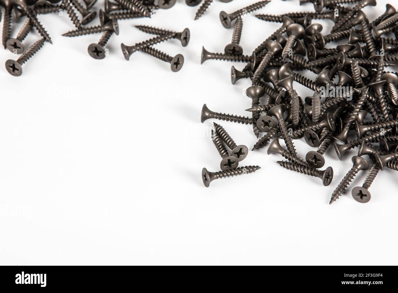 Black screws on a white background. Copy space. Screws for plasterboard ...