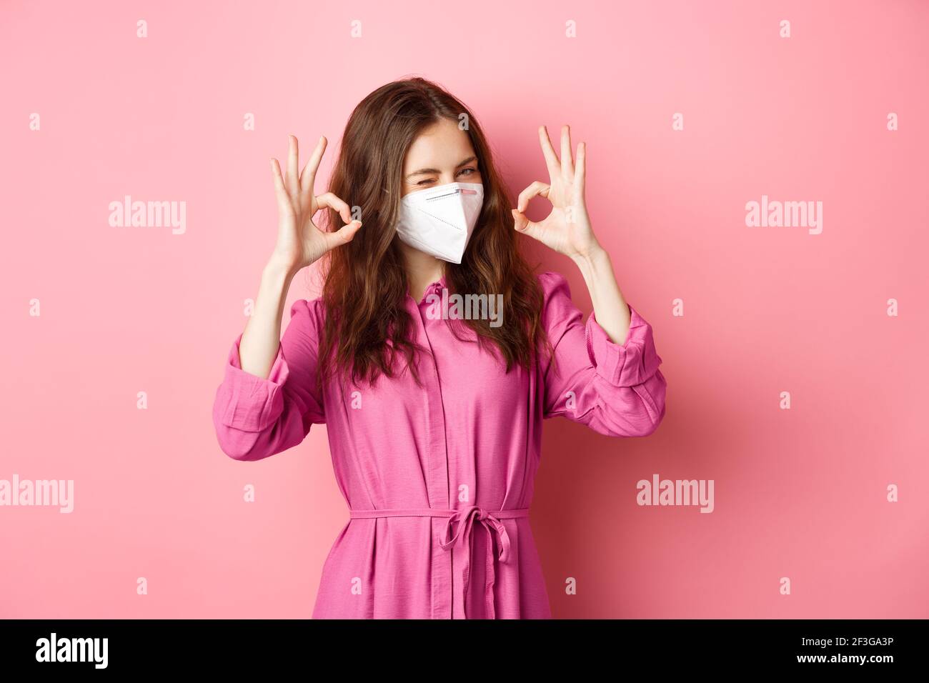 Covid-19, pandemic and lifestyle concept. Cheerful girl shows okay sign ...