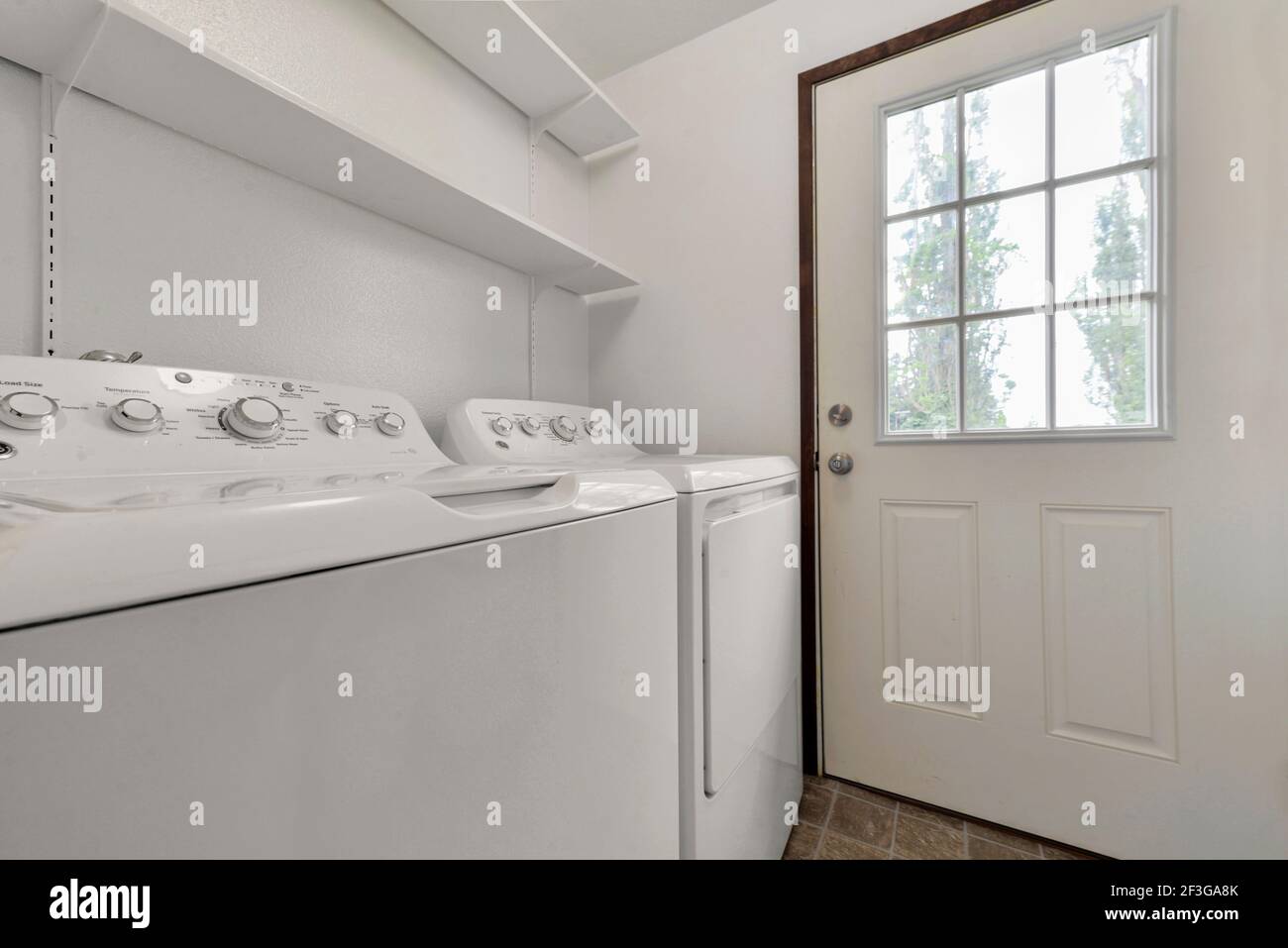 Modern residential laundry room interior Stock Photo - Alamy