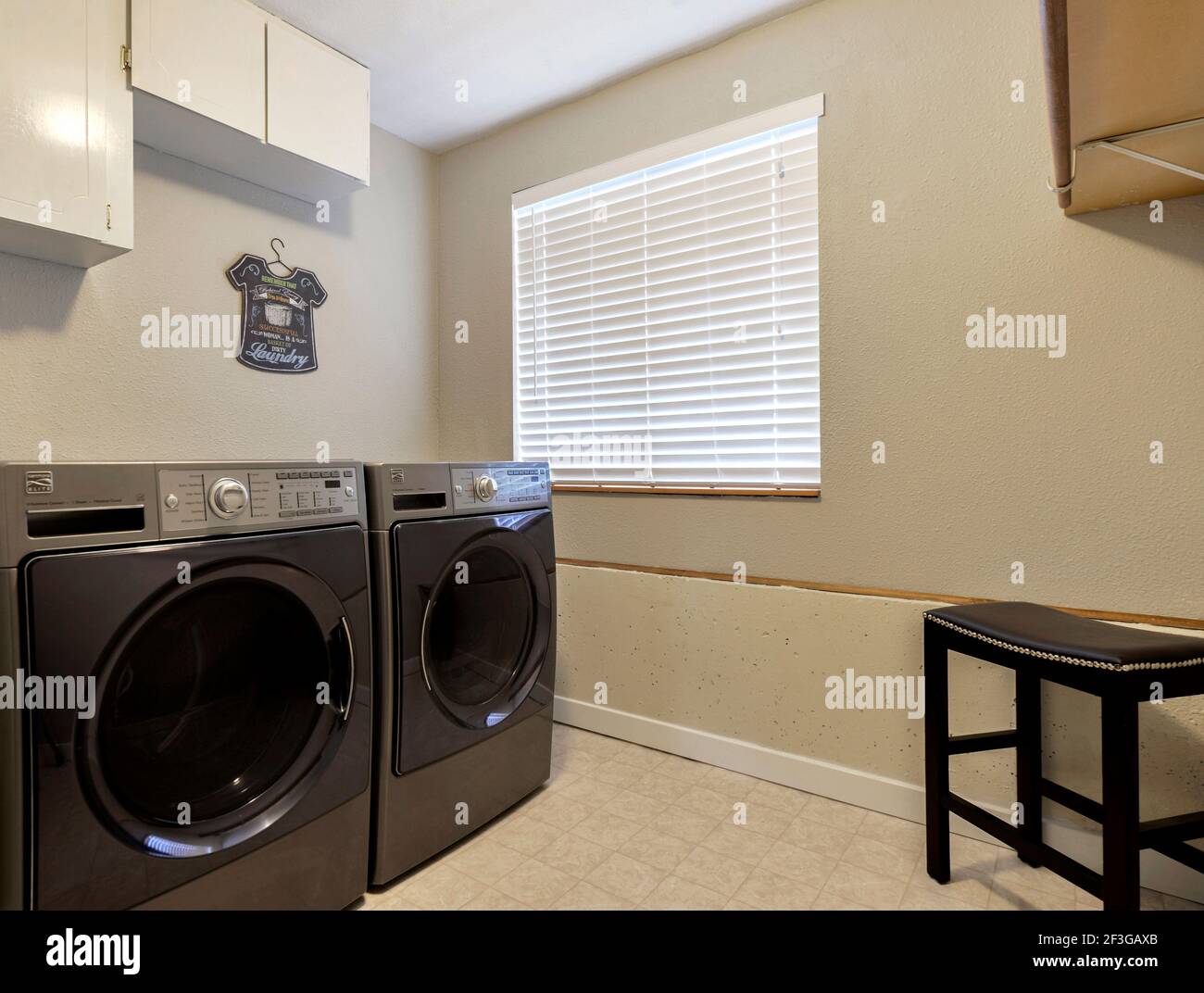 Modern residential laundry room interior Stock Photo - Alamy