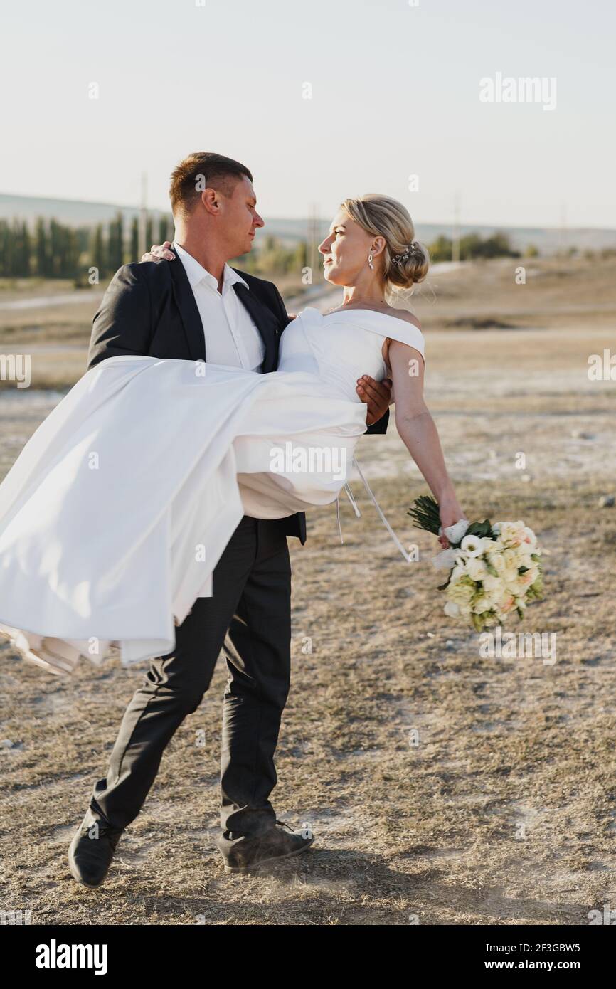 Happy bride and groom looking at each other with a smile Stock Photo ...
