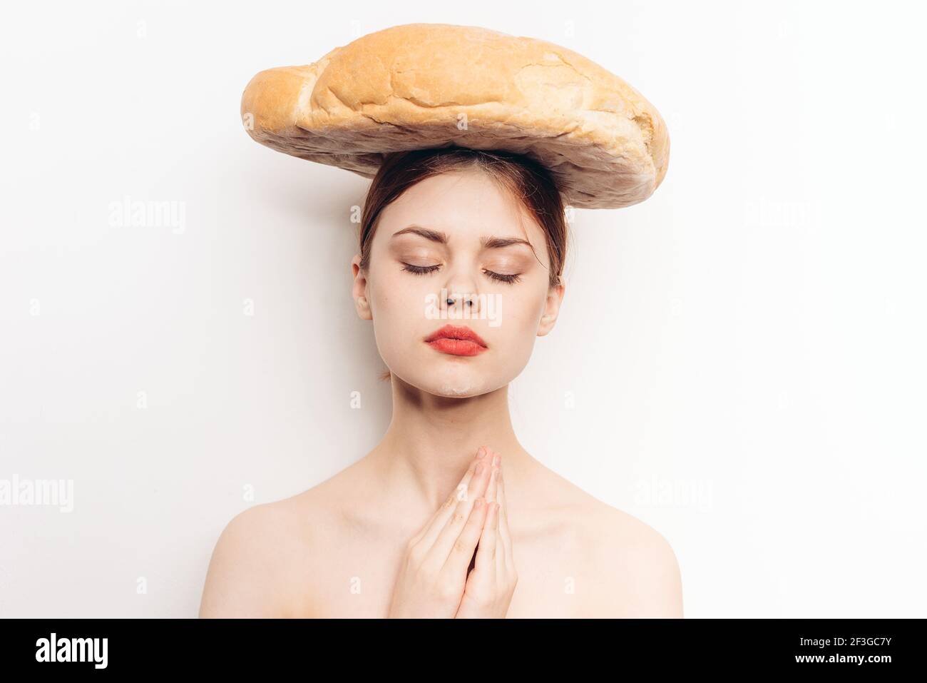 happy woman with a loaf on her head gesturing with her hands meditation ...