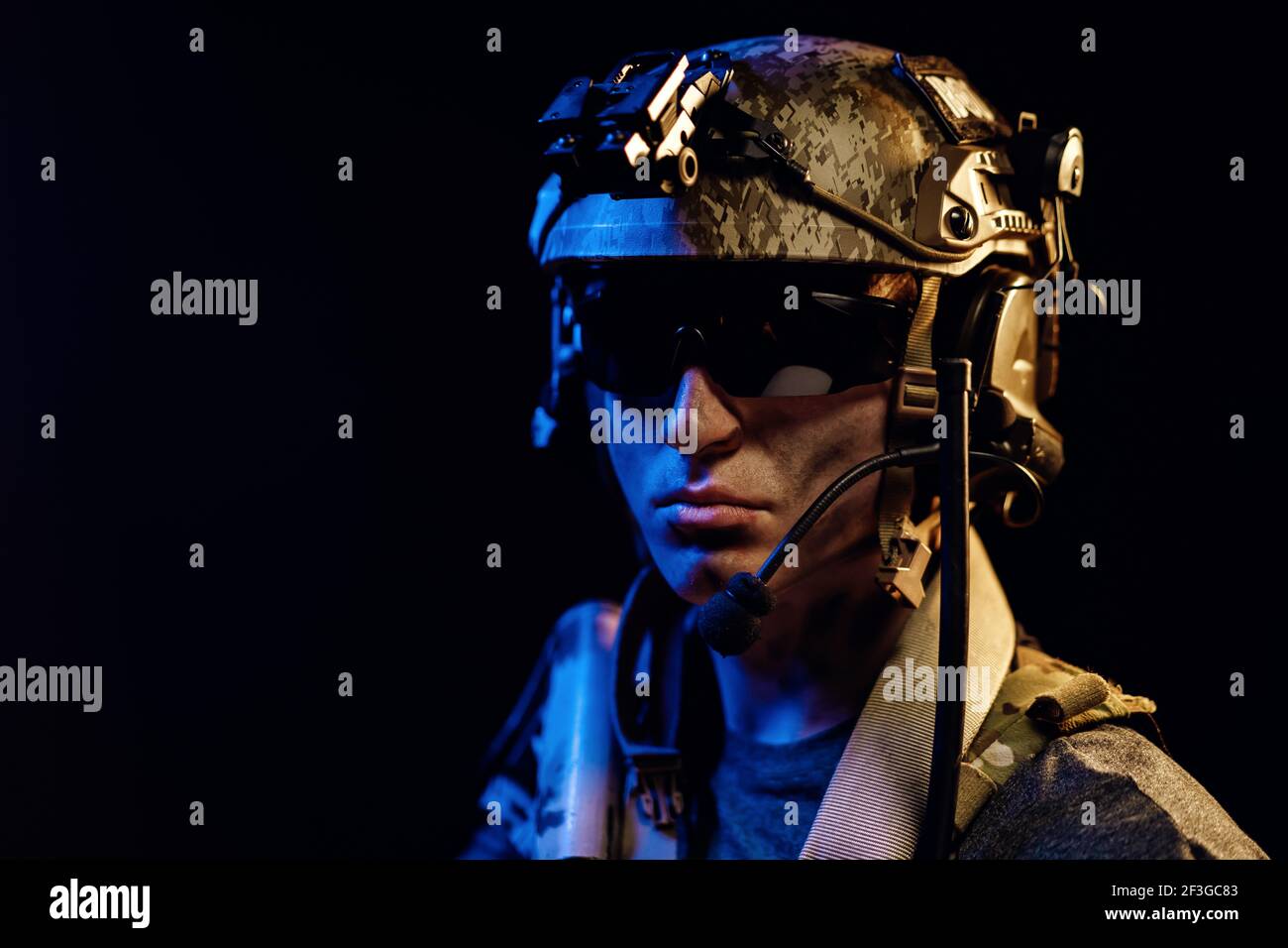 Portrait of special forces soldier in helmet and glasses in the dark ...