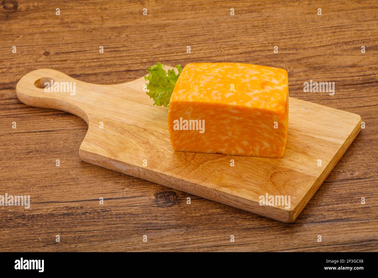 Dairy Marble cheese brick over board Stock Photo - Alamy