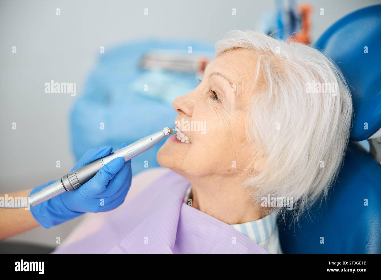 Dental drill with prophy cup cleaning pensioner teeth Stock Photo - Alamy