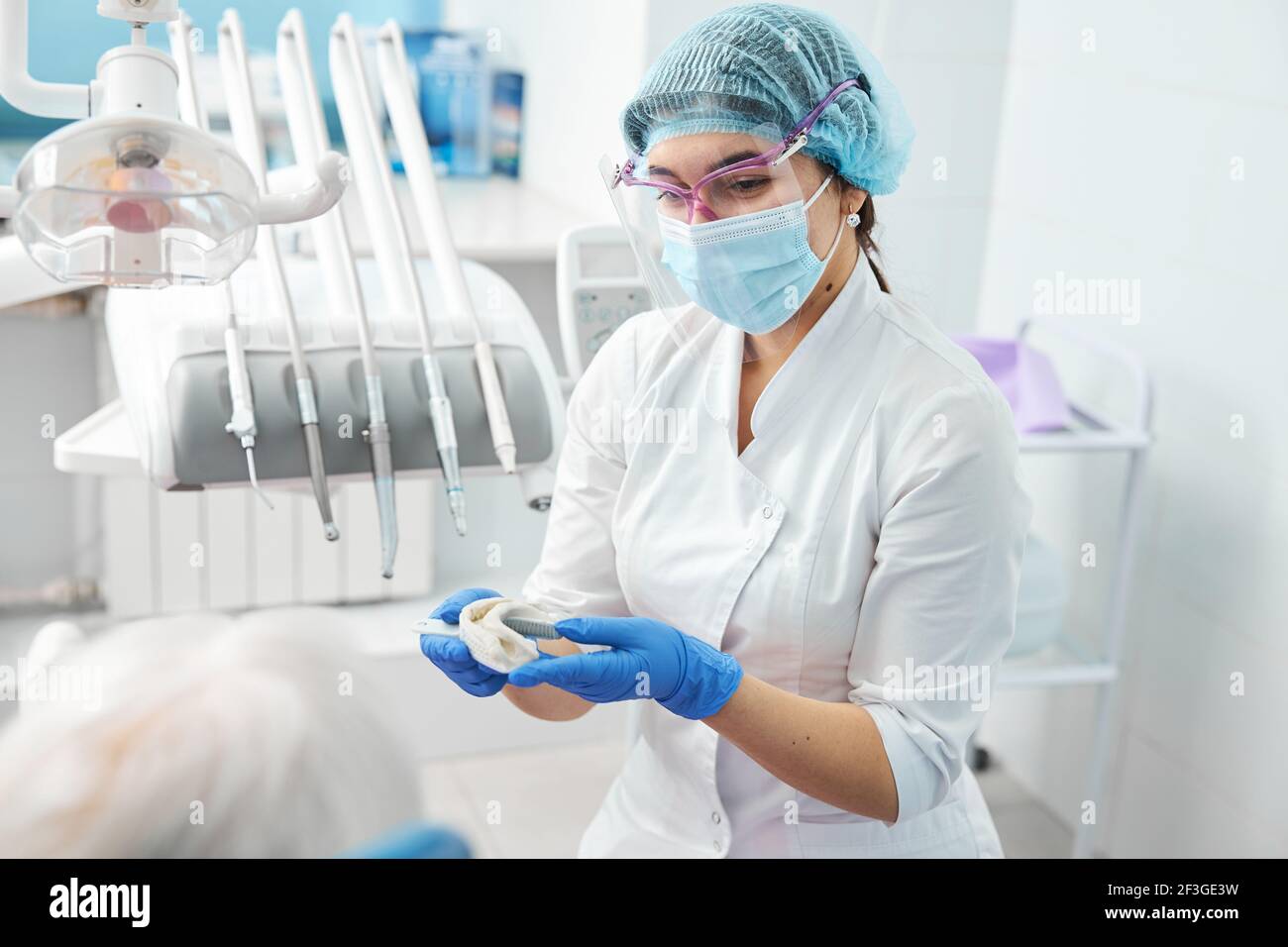 Doctor in dentist office with a teeth cast Stock Photo - Alamy