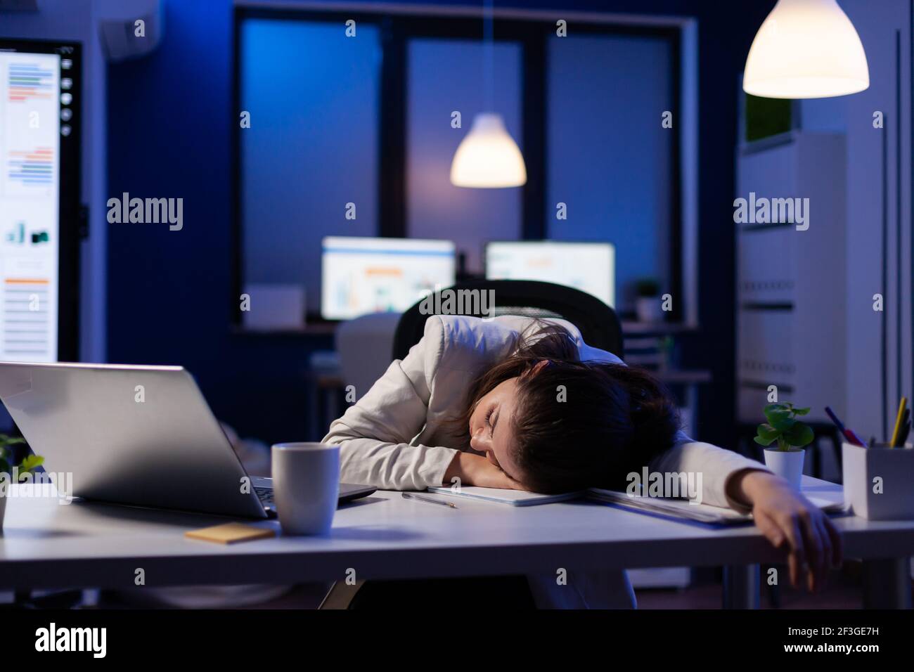 Exhausted overload business woman falling asleep on desk with open ...