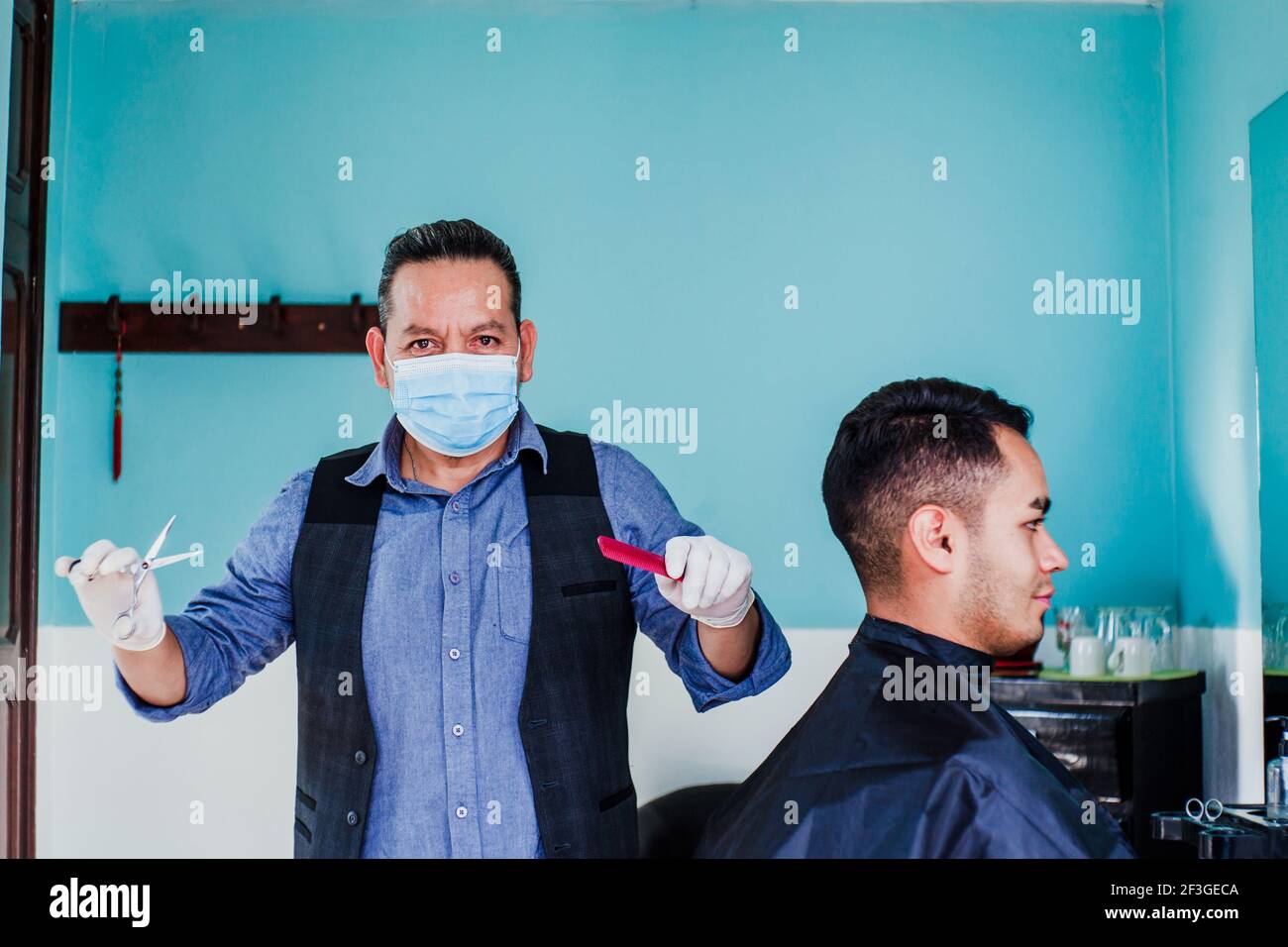 Mexican barber at work with his customer hi-res stock photography and ...