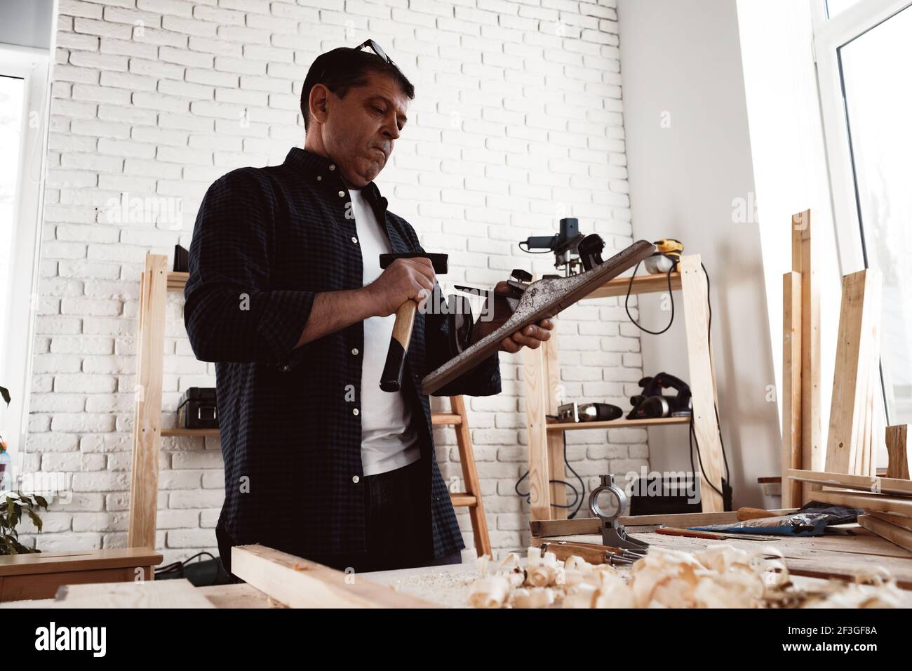 Carpenter's hands planing a plank of wood with a hand plane Stock Photo ...