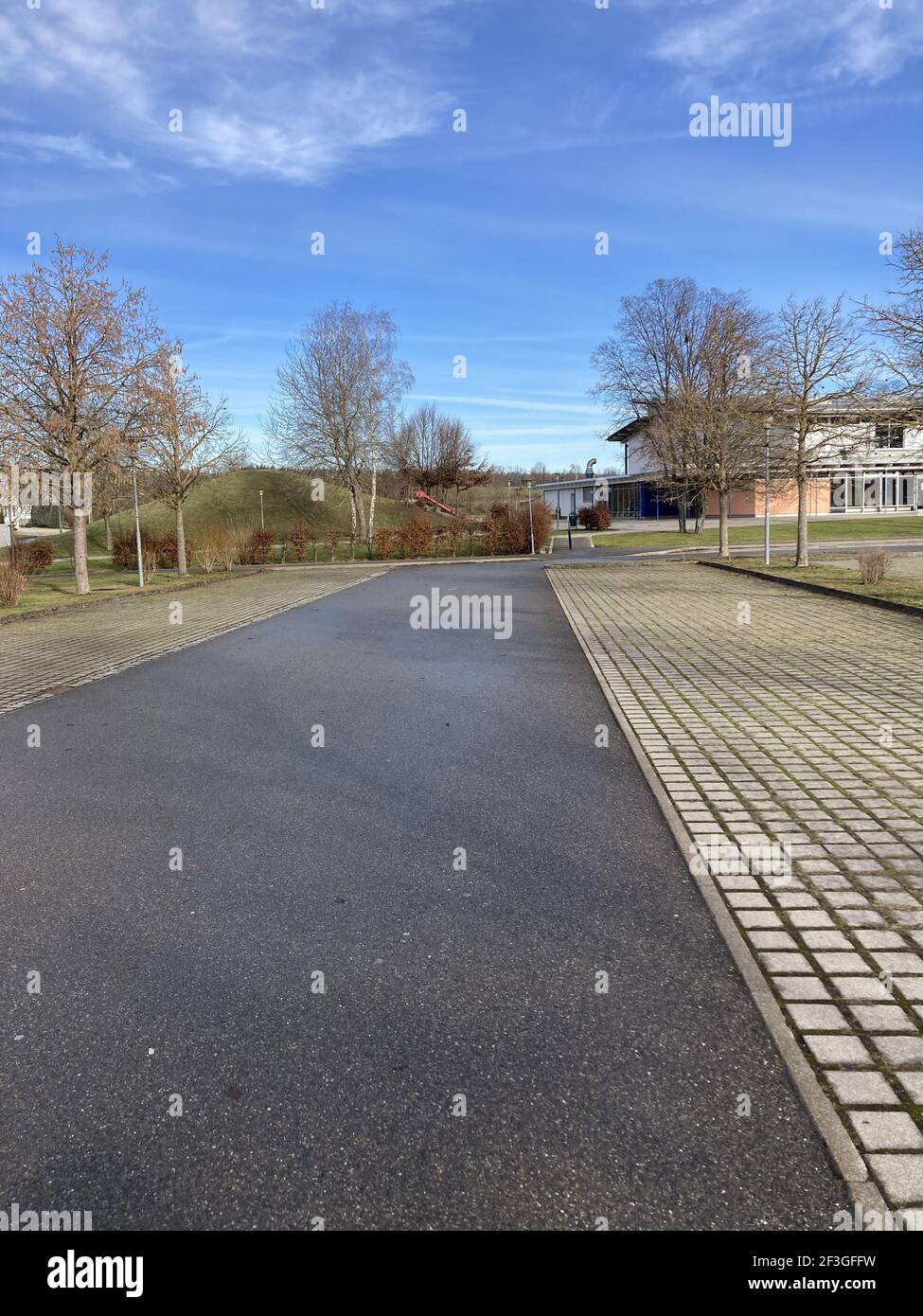 An empty suburban road under a blue sky Stock Photo - Alamy