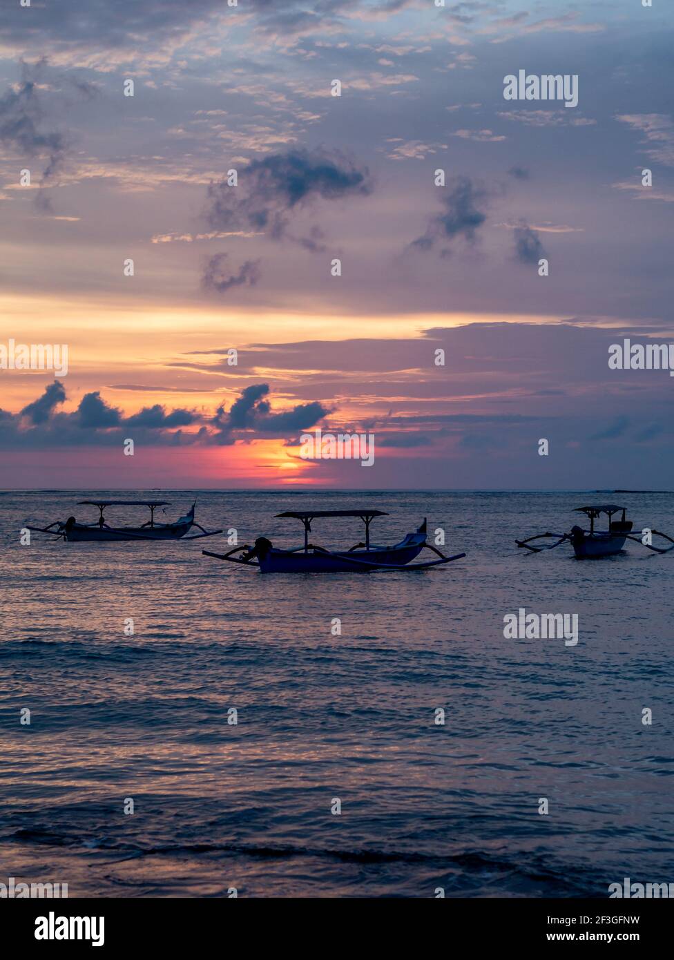 Sunset at the beach in Kuta Bali Stock Photo - Alamy