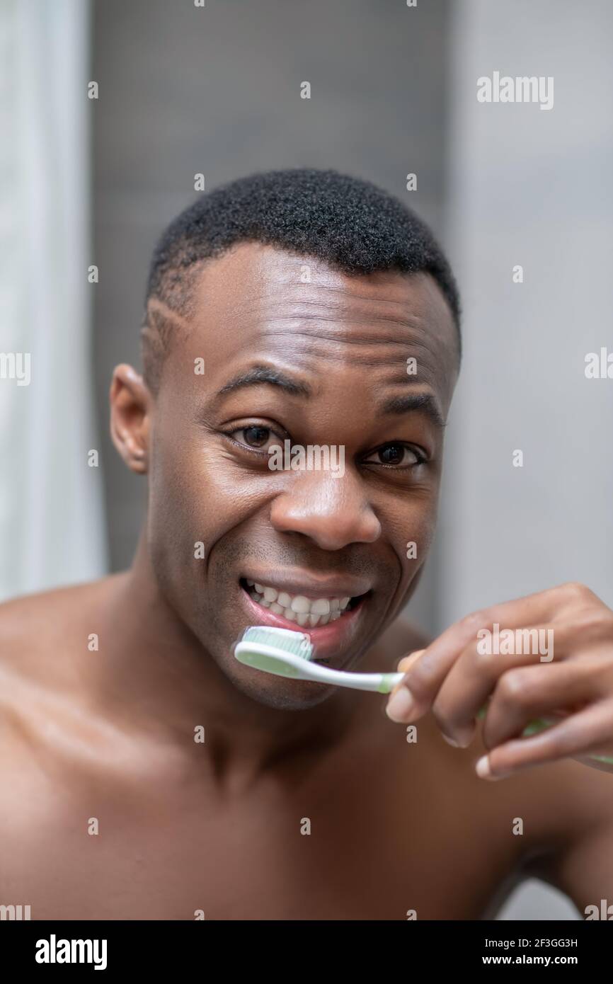 African american young handsome man cleaning his teeth Stock Photo - Alamy