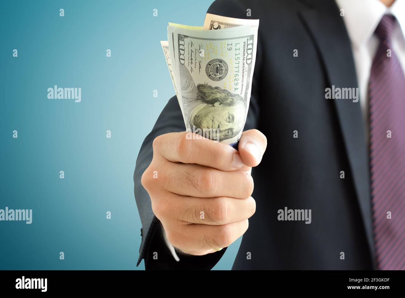 Businessman hand grabbing money, US dollar (USD) bills Stock Photo - Alamy