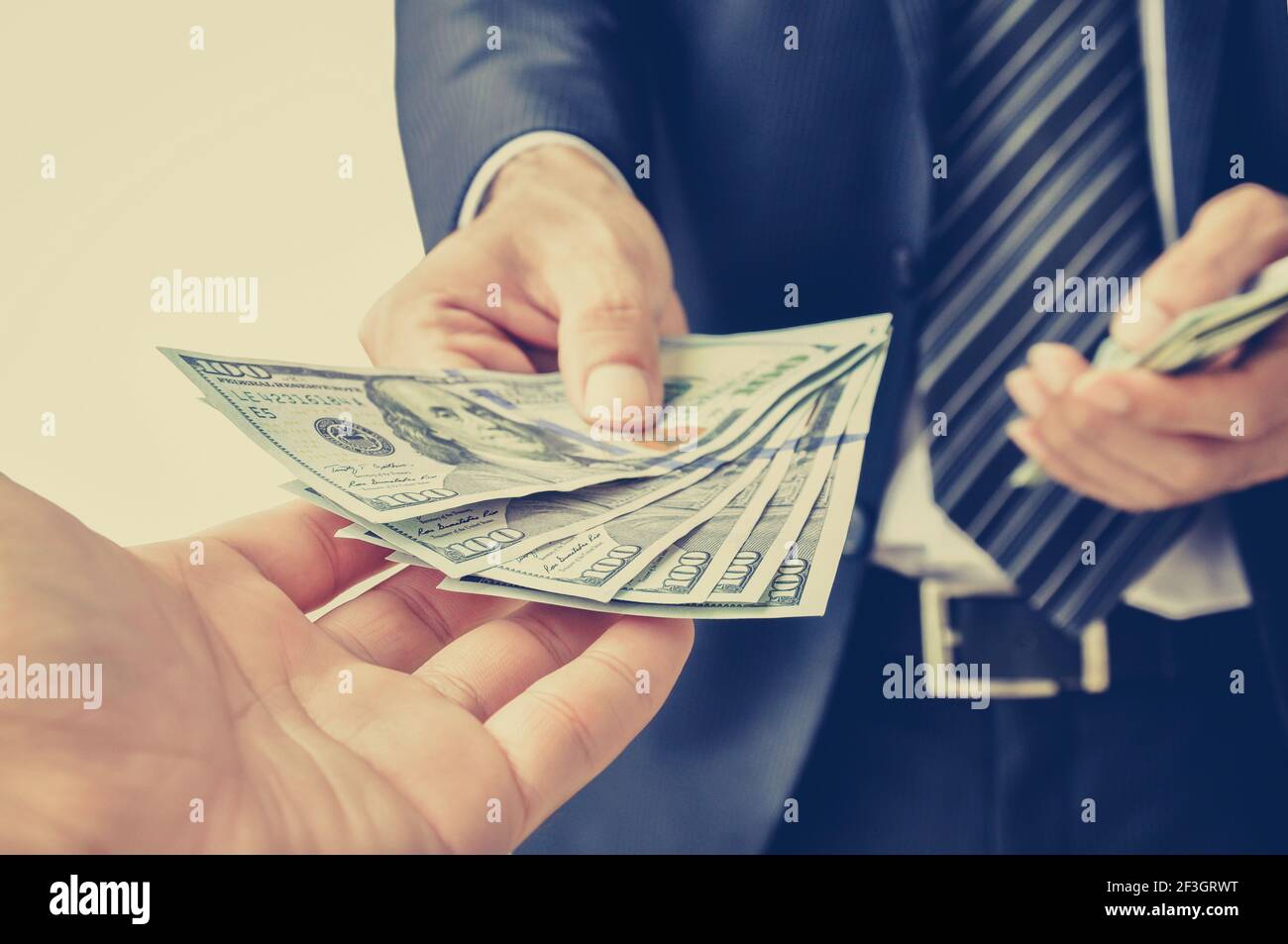 Hand receiving money, US dollar (USD) bills, from businessman hand ...