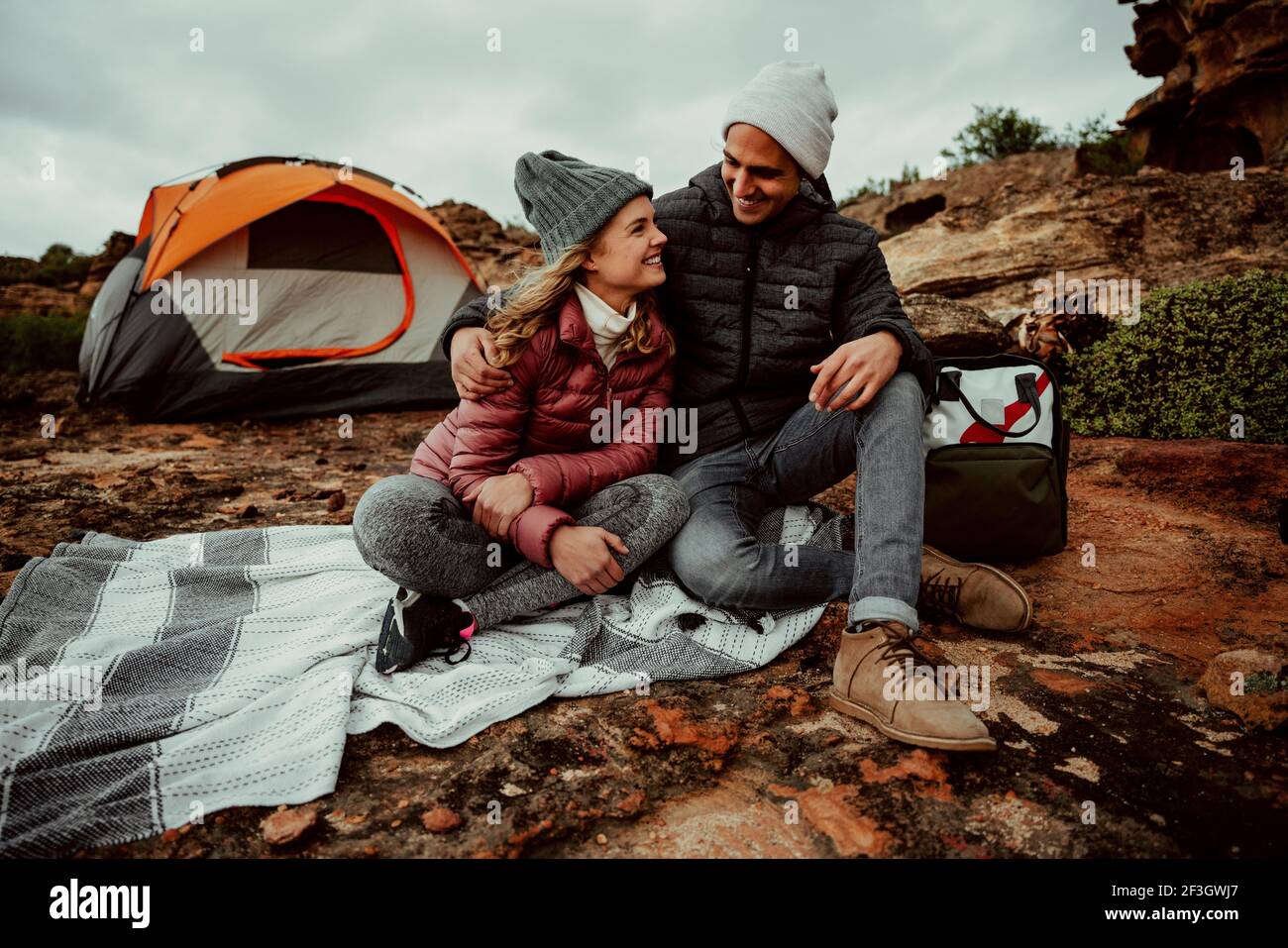 Caucasian romantic couple camping in wilderness cuddling Stock Photo ...