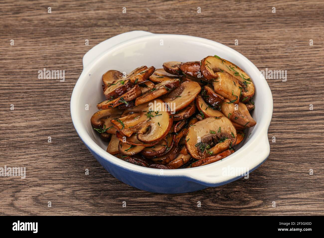 Roasted champignon with herbs and spices in the bowl Stock Photo - Alamy