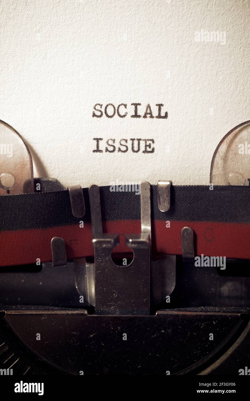 Social issue phrase written with a typewriter Stock Photo - Alamy
