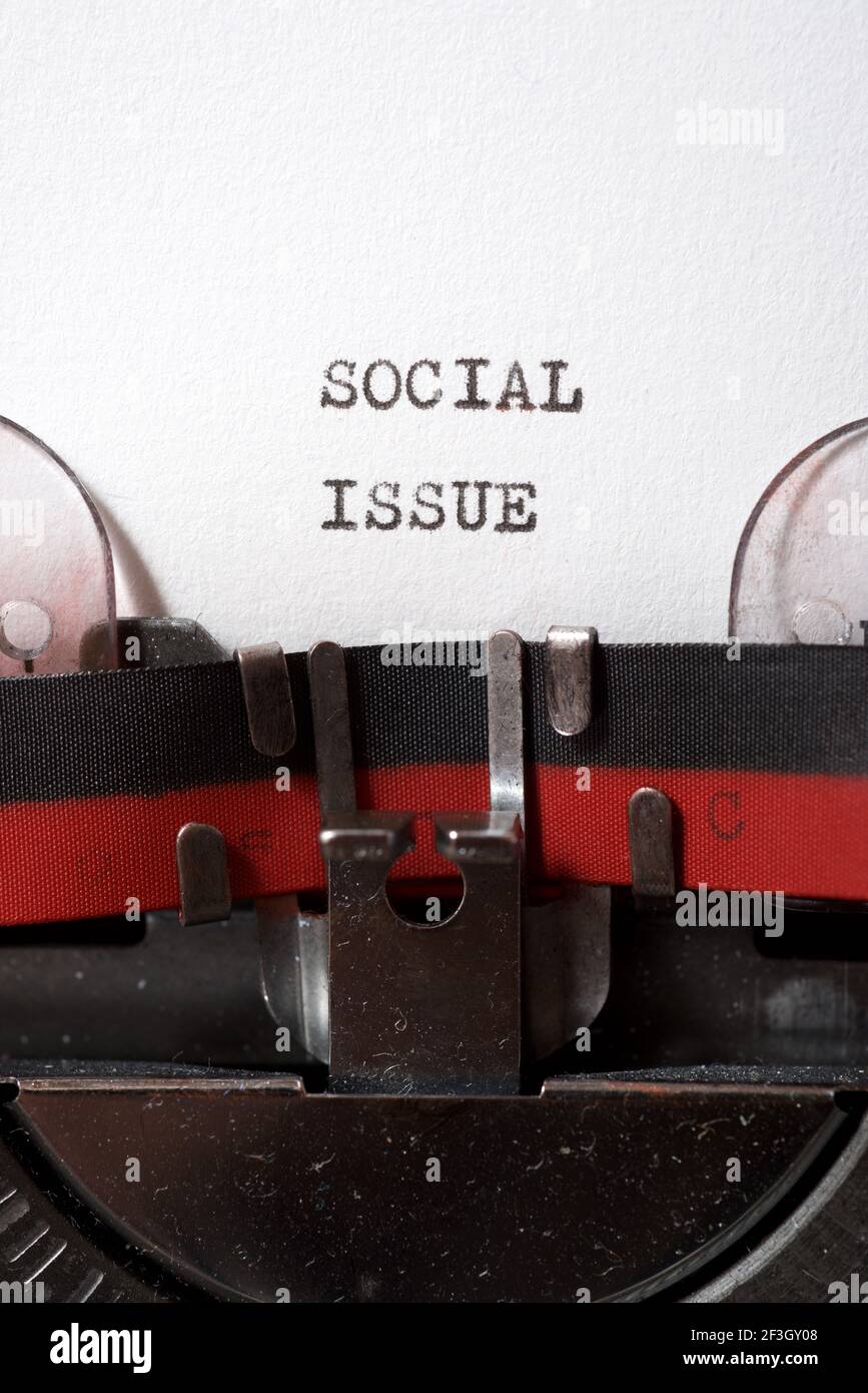 Social issue phrase written with a typewriter Stock Photo - Alamy