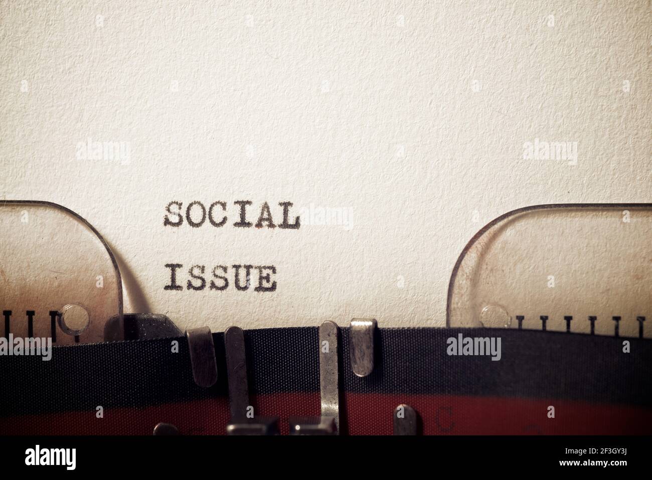Social issue phrase written with a typewriter Stock Photo - Alamy