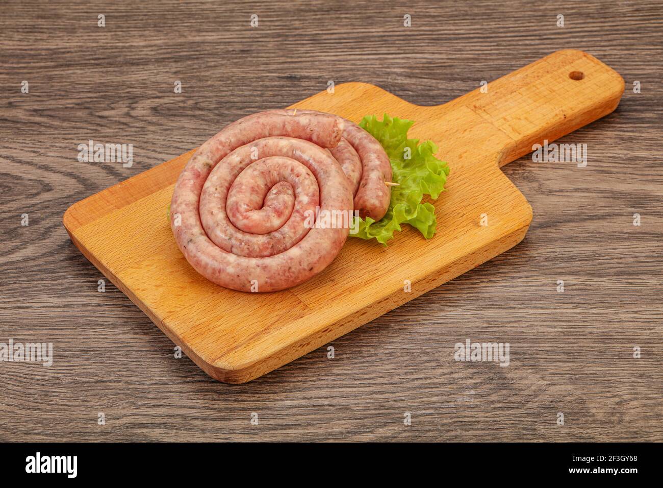 Raw pork sausage ring for grill Stock Photo - Alamy
