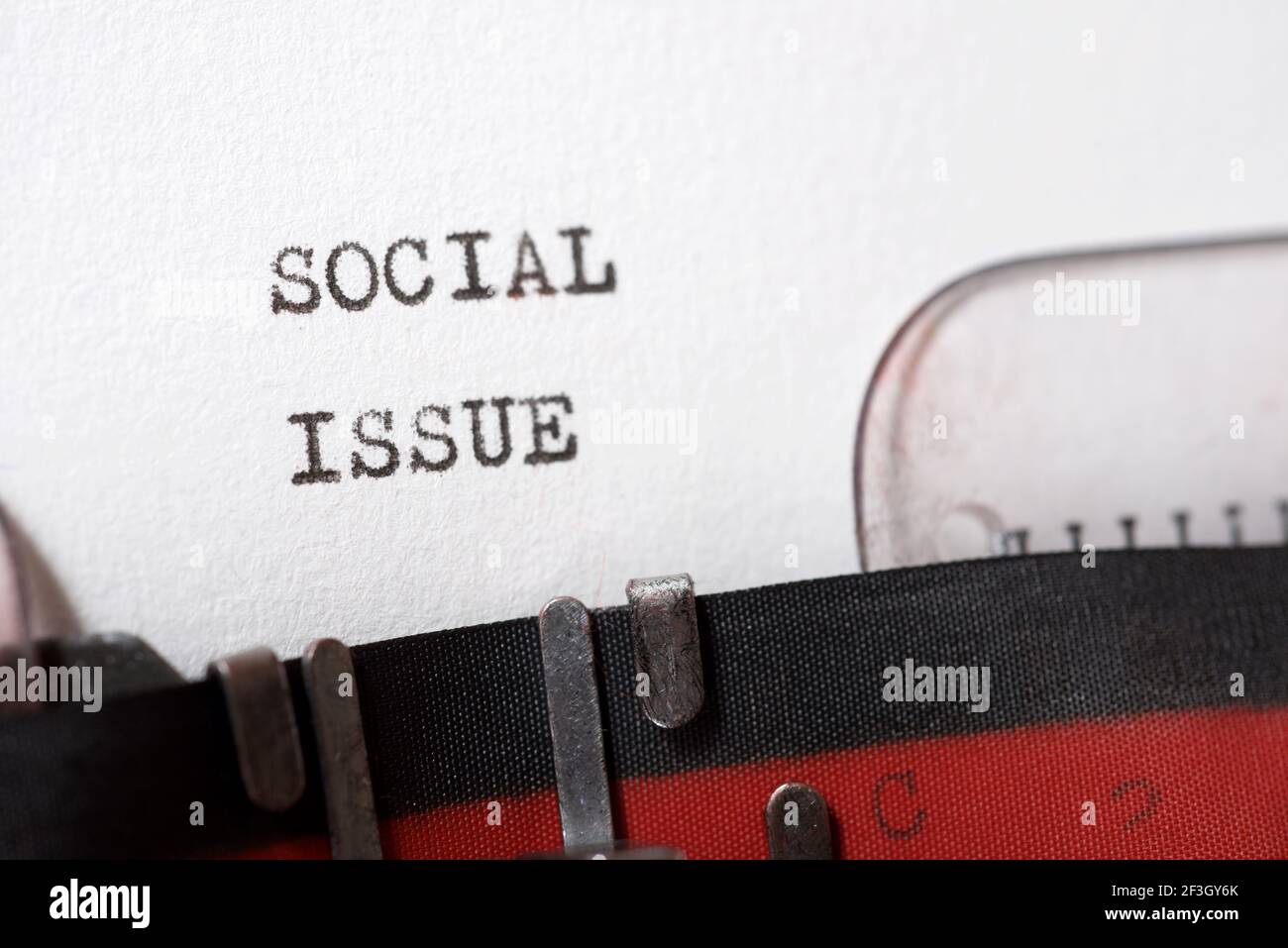 Social issue phrase written with a typewriter Stock Photo - Alamy