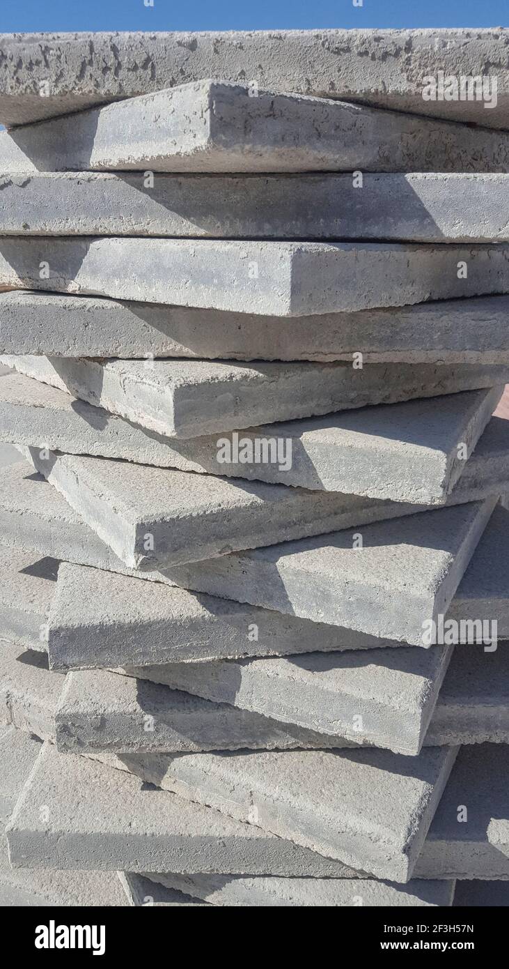 Stacks of paving slabs in piles ready to place on pavement. Closeup ...
