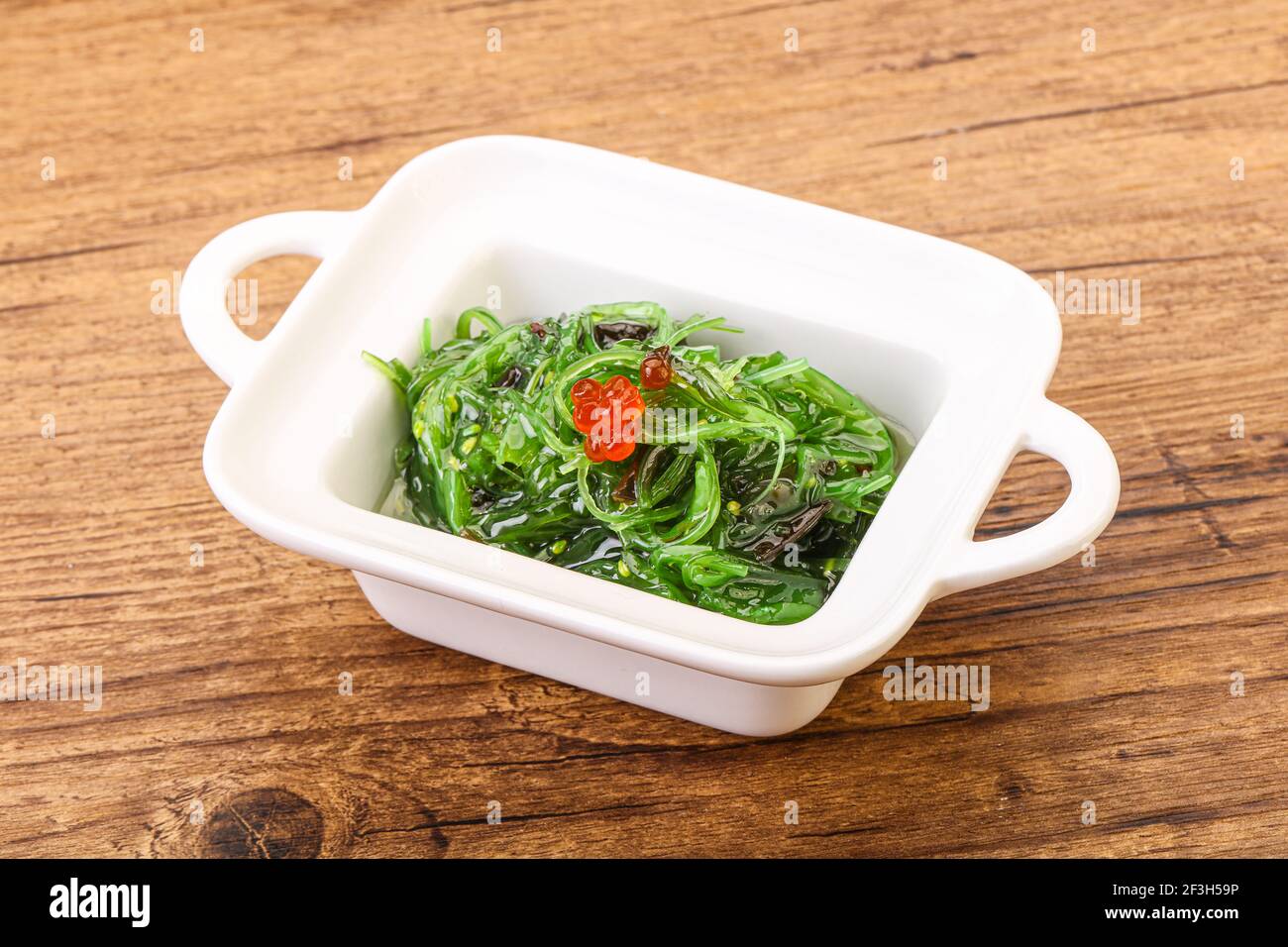 Asian traditional chukka salad in the bowl served red caviar Stock ...