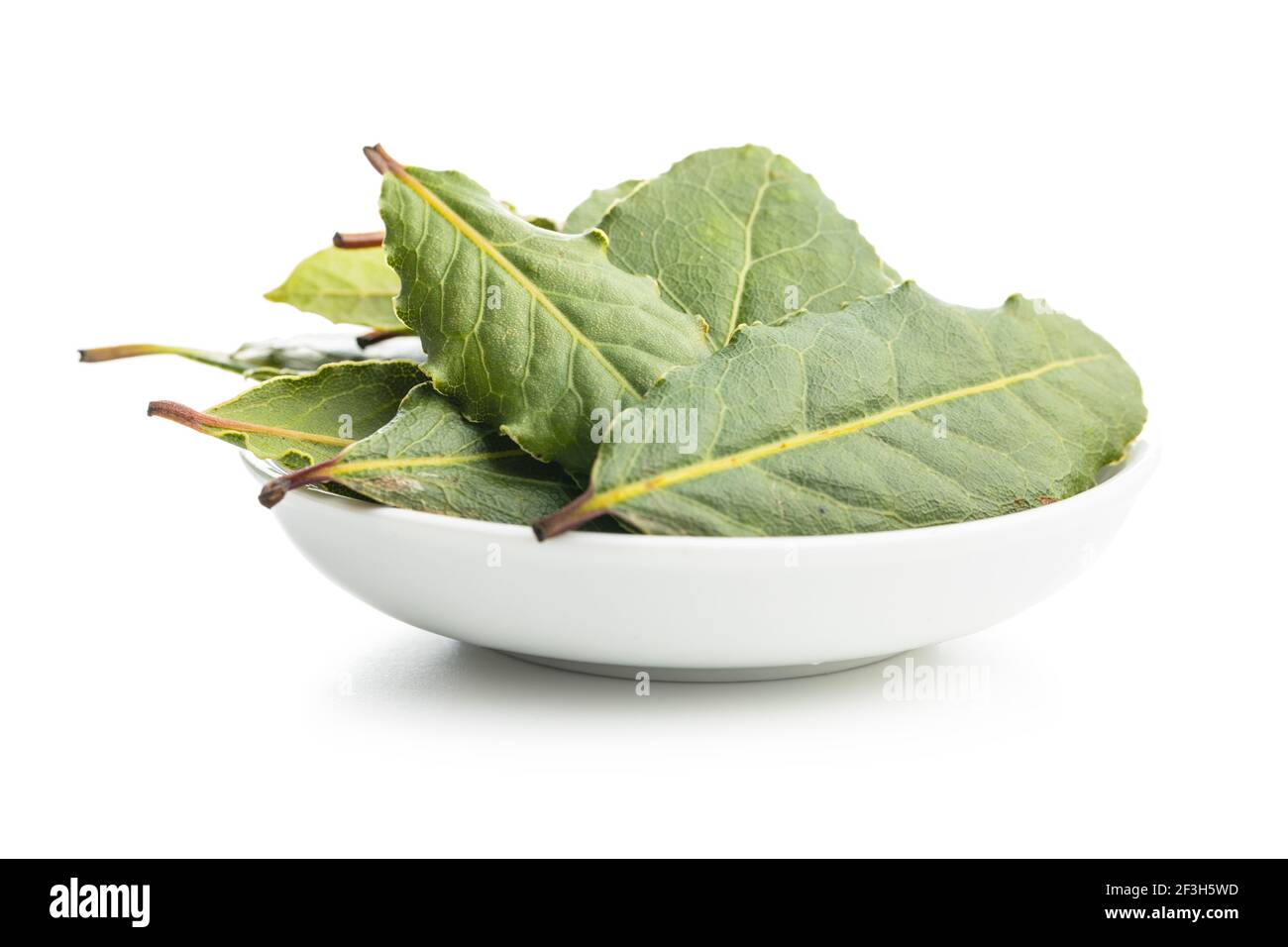 Fresh green bay leaves in bowl isolated on white background Stock Photo ...