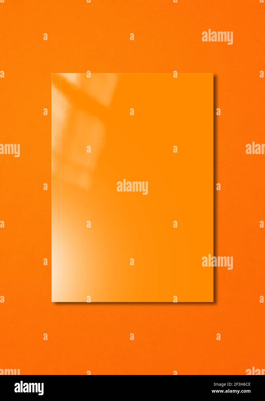 Orange booklet cover isolated on colorful background, mockup template ...