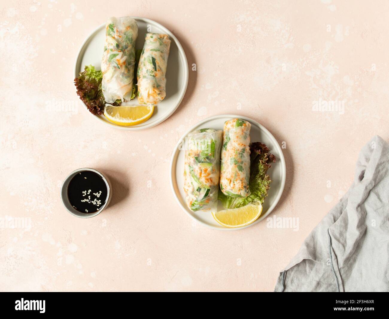 Vietnamese spring rolls with salad, sauce, crab, and noodles on plates ...