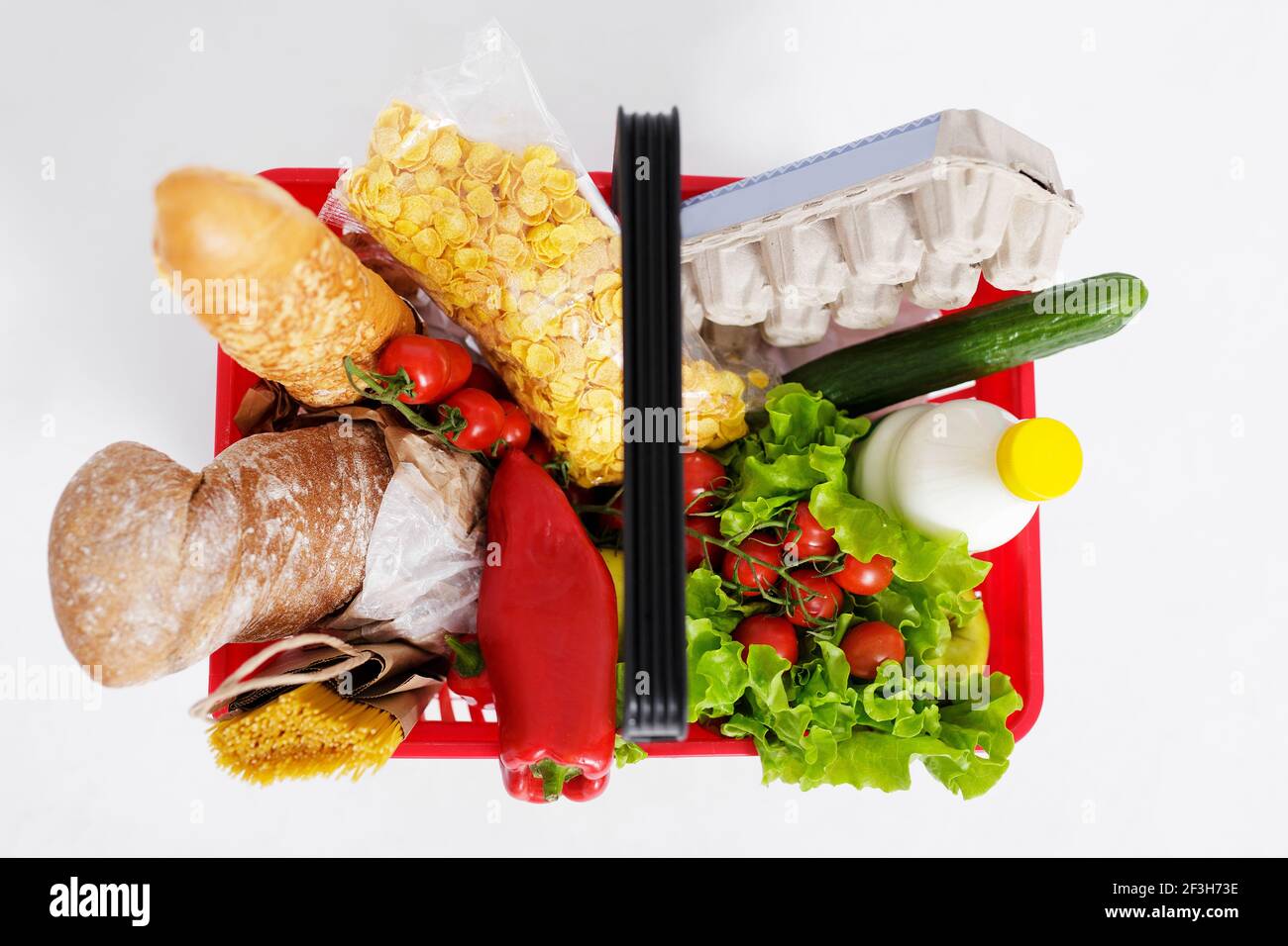 close up top view of shopping basket full of products over white ...