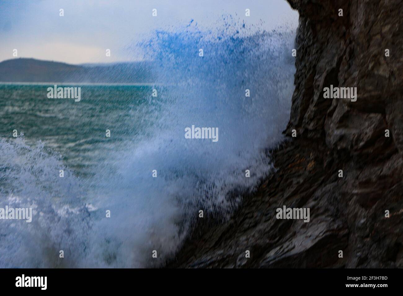 Atlantic storm waves crashing up and washing over rocks and sand on the ...