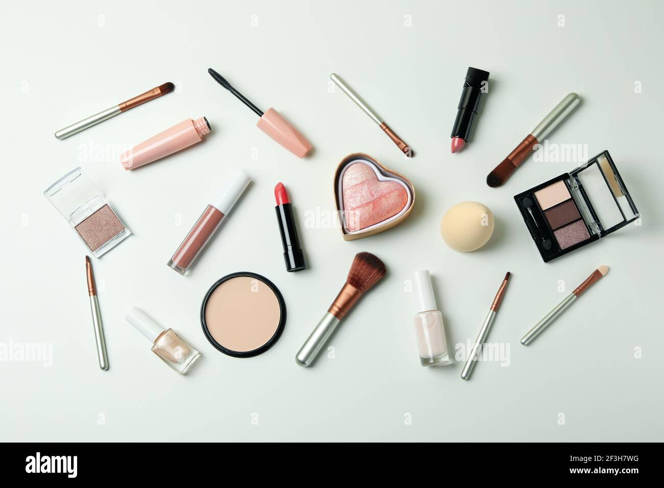 Different makeup cosmetics on white background, top view Stock Photo ...