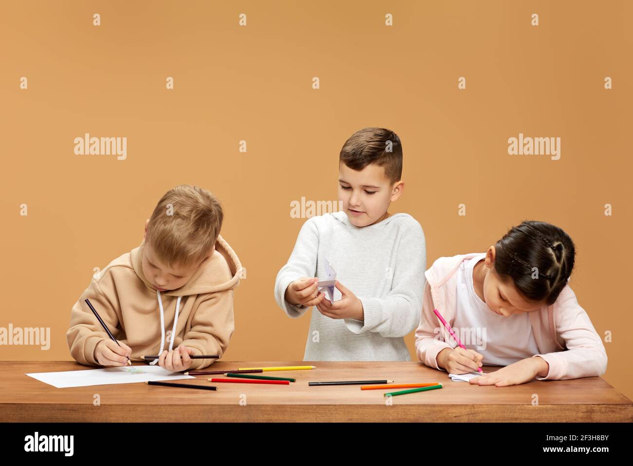 happy children draw together at the table Stock Photo - Alamy