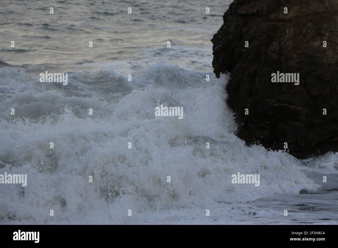 Atlantic storm waves crashing up and washing over rocks and sand on the ...