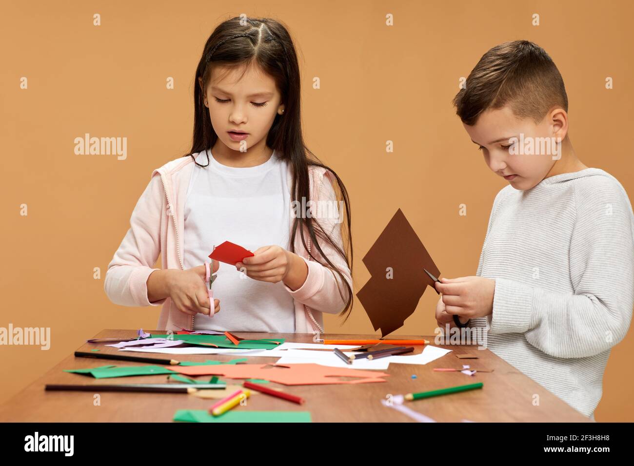 happy children cutting colored papers with scissors Stock Photo - Alamy