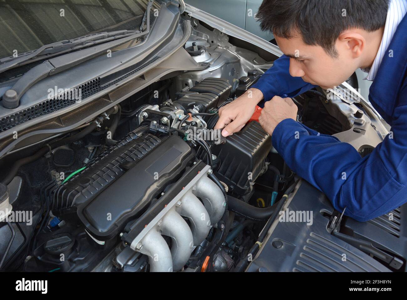 Auto mechanic (or technician) fixing car engine Stock Photo - Alamy
