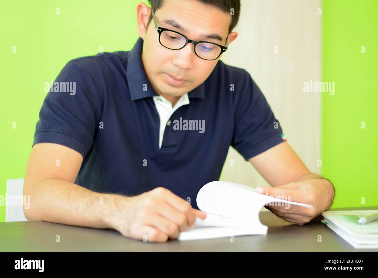 A man reading book on the table - studying & exam concept Stock Photo ...