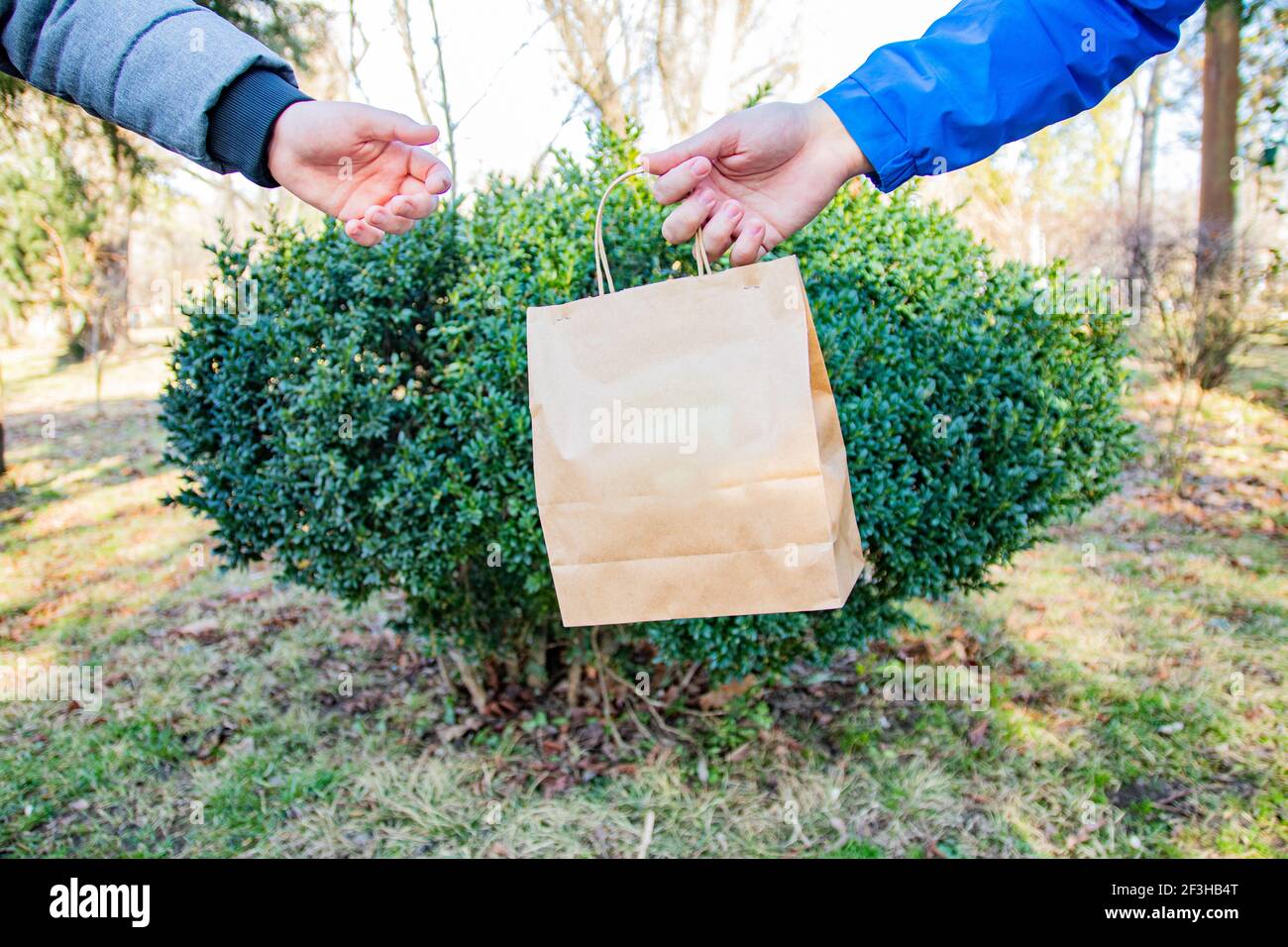 Delivery man handing paper bags Stock Photo - Alamy