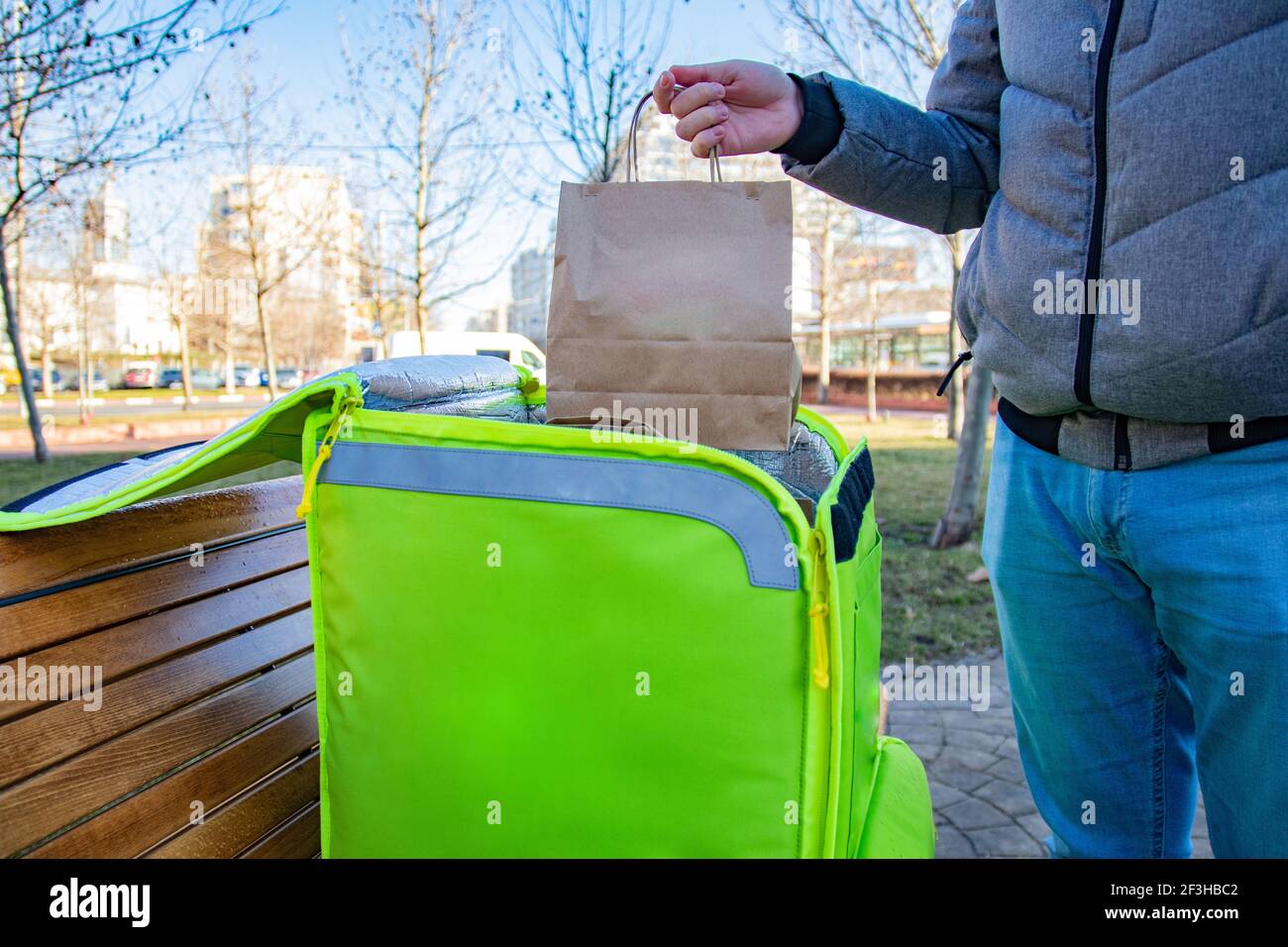 Delivery man handing paper bags Stock Photo - Alamy