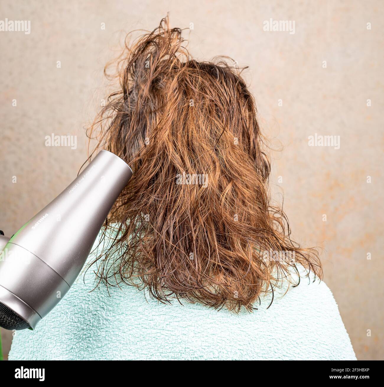 Hairdresser drying long brown hi-res stock photography and images - Alamy