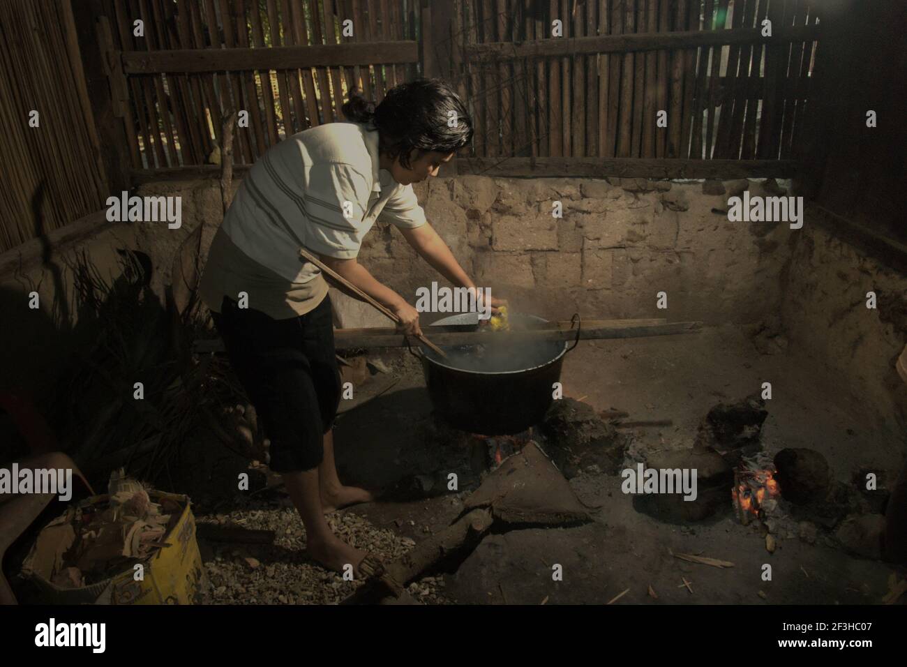 A woman boiling yarns for colouring, an initial process in the making ...