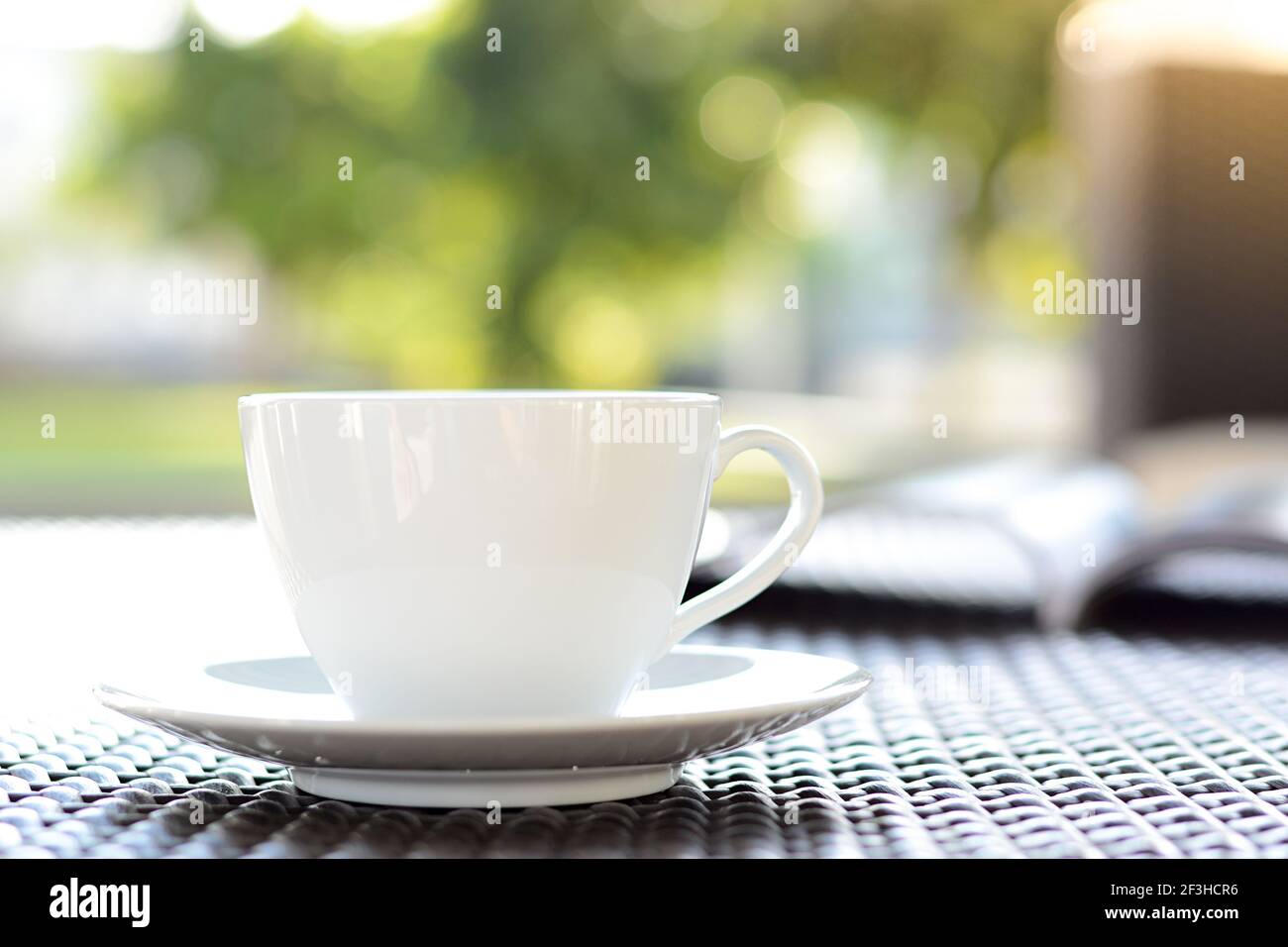 Coffee cup with book on blurred green nature background - chill out ...