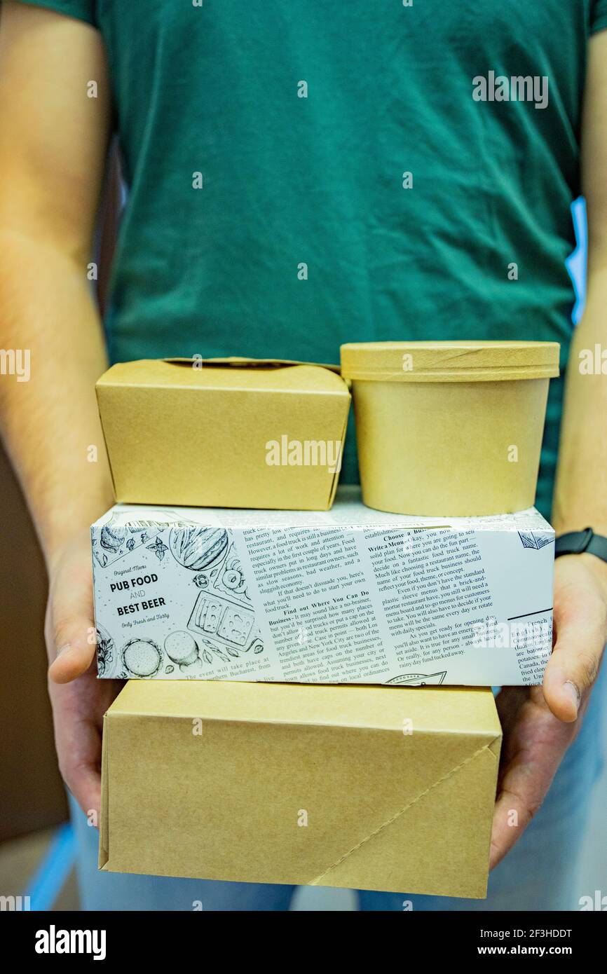 Man holding packed food in arms Stock Photo - Alamy