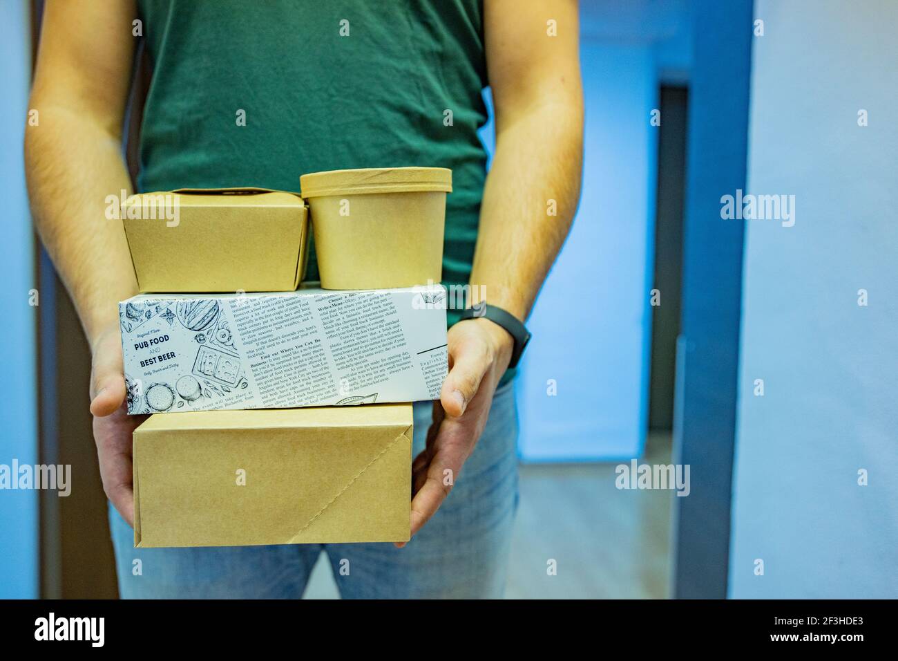 Man holding packed food in arms Stock Photo - Alamy